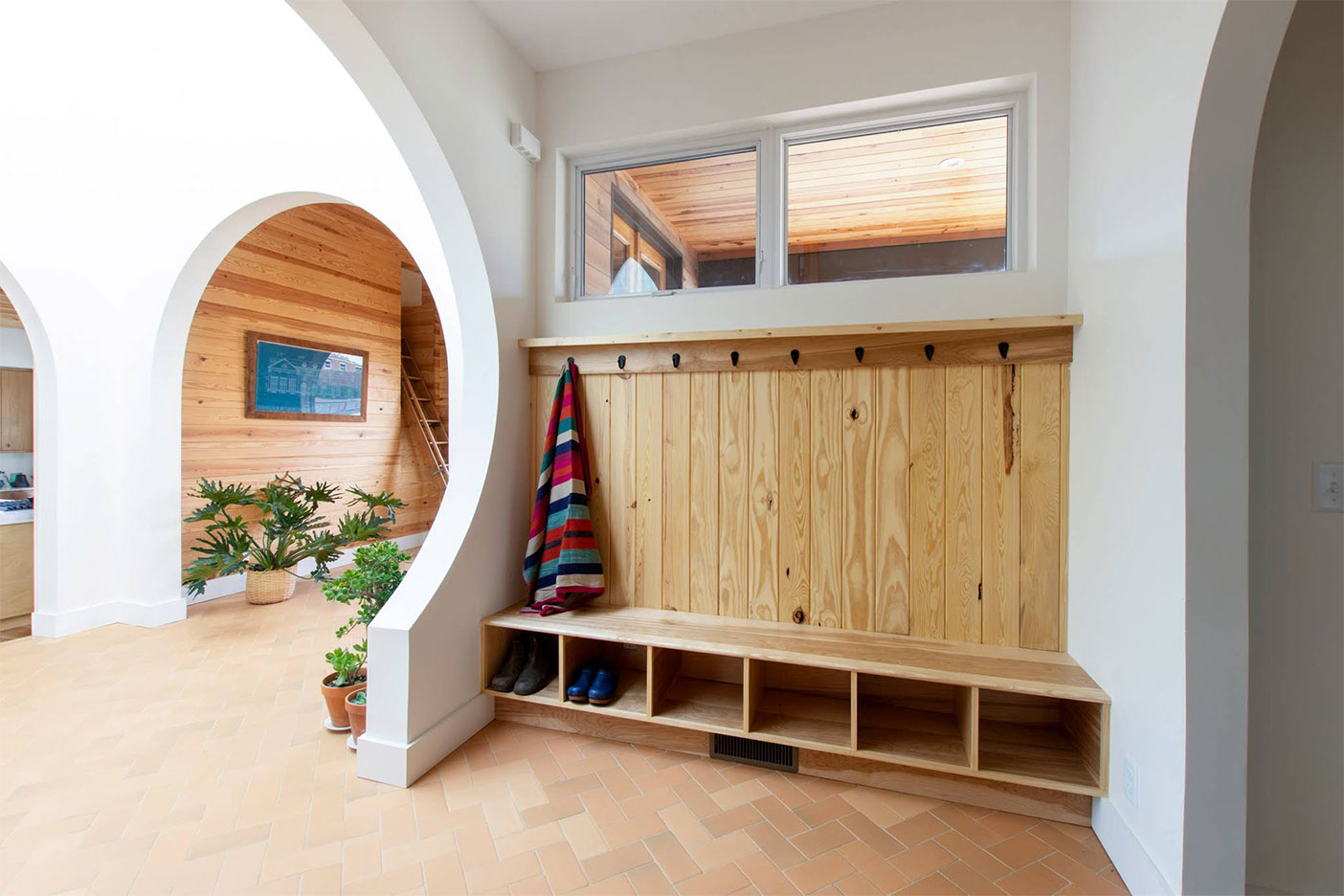 A Keyhole Archway Hides Shoe Cubbies in This Asheville Home's Front Hallway