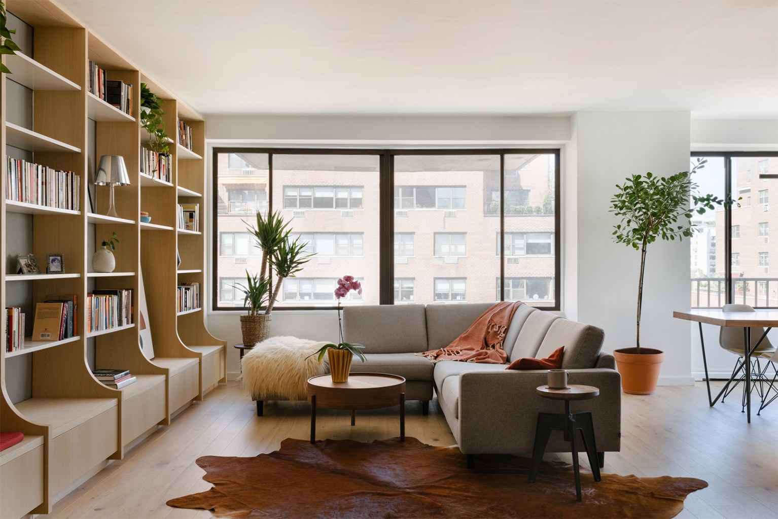 The Built-In Bookcase in This NYC Home Serves as Seating and Kitchen ...