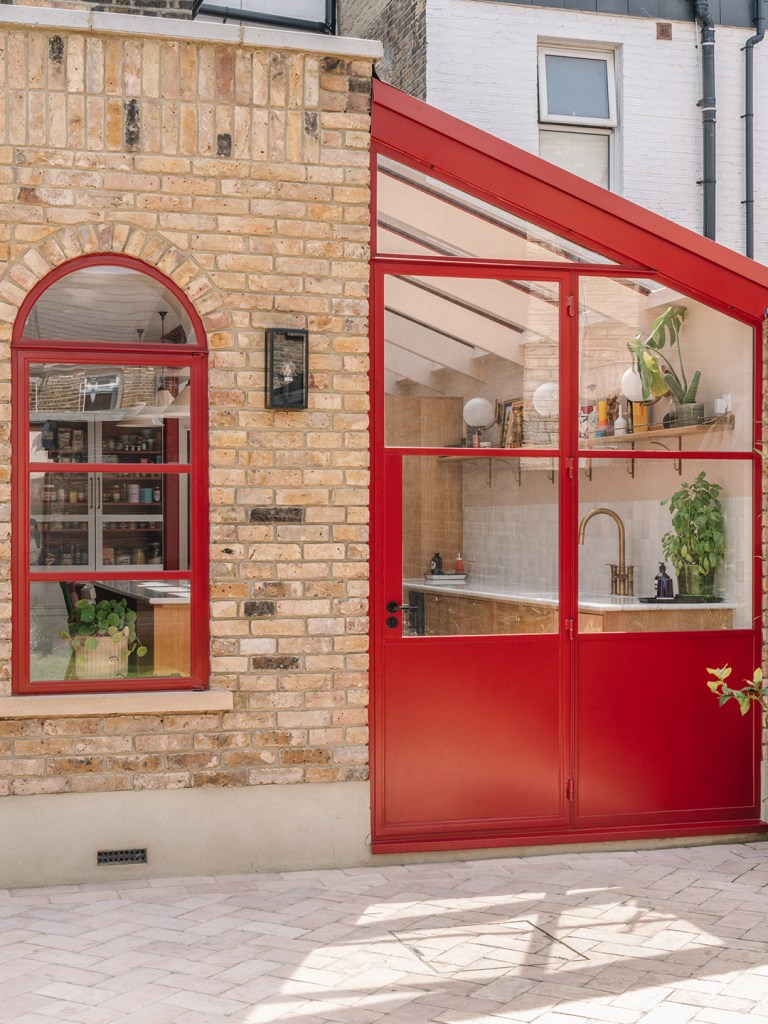 This Architect's Bright Red Kitchen Windows and Beams Can’t Go Unnoticed